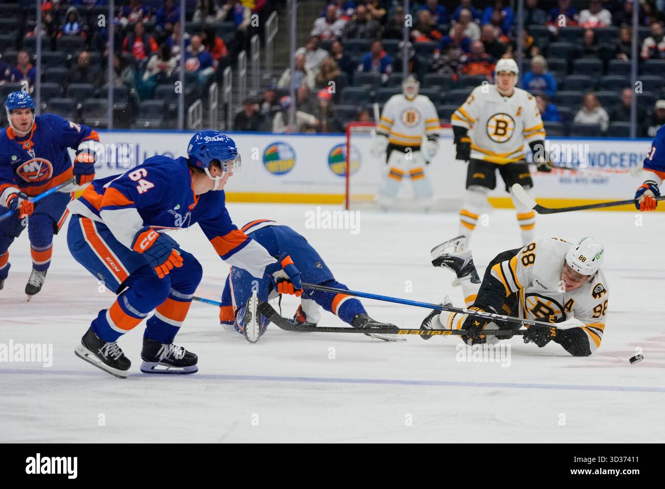 Boston Bruins' David Pastrnak (88) fights for control of the puck with ...