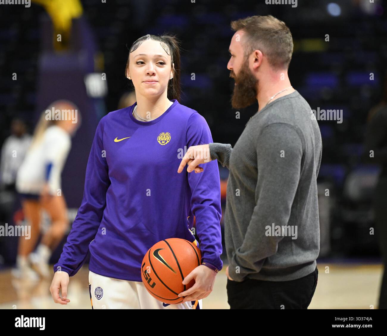 LSU Tigers guard Bella Hines (3), left, and assistant strength coach ...