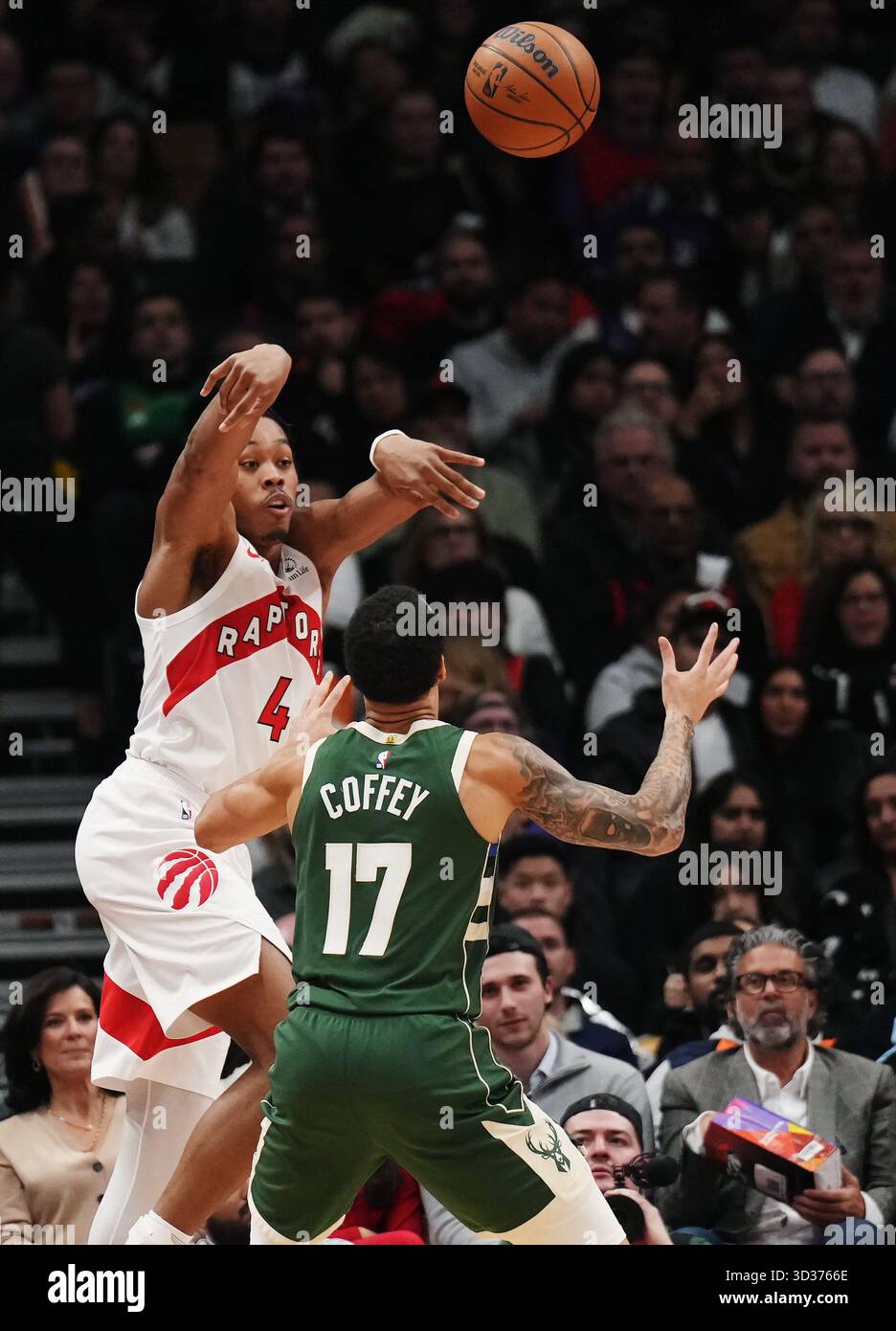 Toronto Raptors' Scottie Barnes (4) passes over Milwaukee Bucks' Amir ...