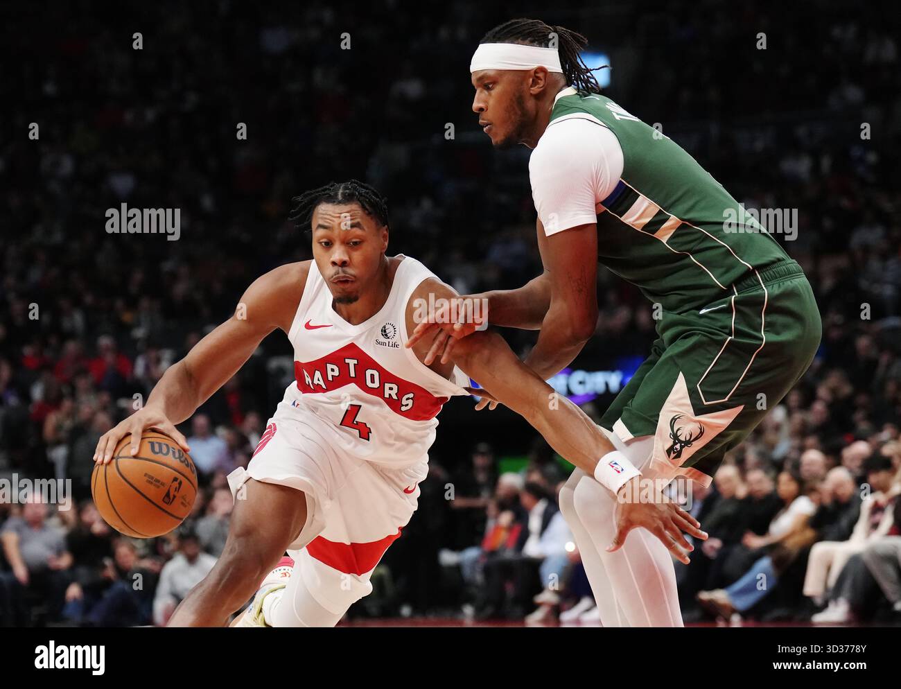 Toronto Raptors' Scottie Barnes (4) drives past Milwaukee Bucks' Myles ...