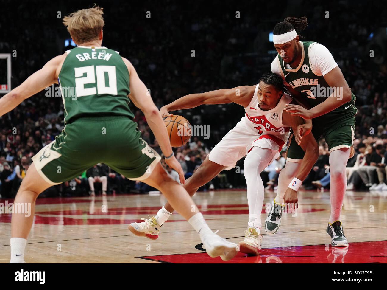 Toronto Raptors' Scottie Barnes (4) tries to get between Milwaukee ...