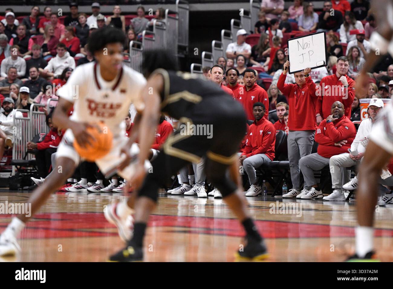 A Texas Tech coaching staff raises a whiteboard during the first half ...