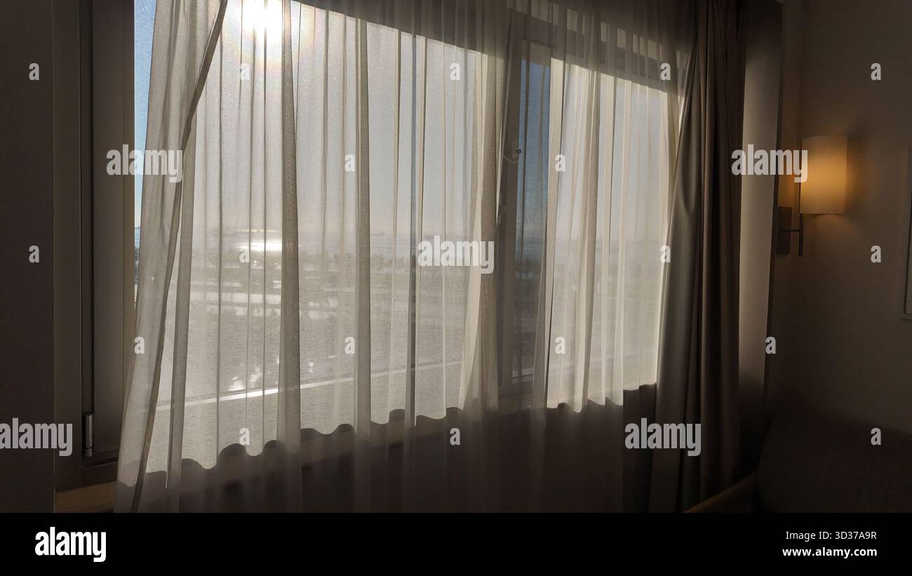 Sunlight shines through sheer curtains hi-res stock photography and ...