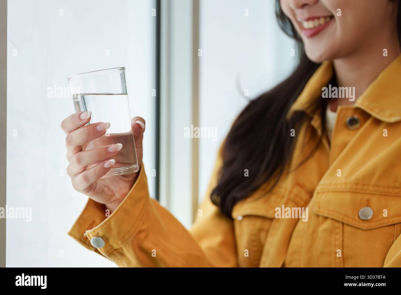 Lifestyle. Woman enjoying a refreshing glass of water indoors Stock ...