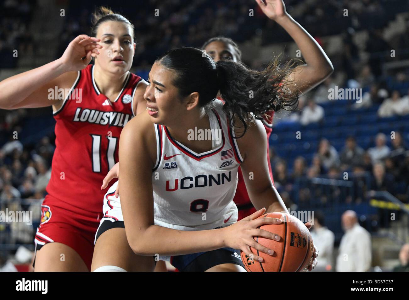 UConn center Jana El Alfy (8) looks to pass as Louisville forward Elfi Istanbulluoglu (11 ...