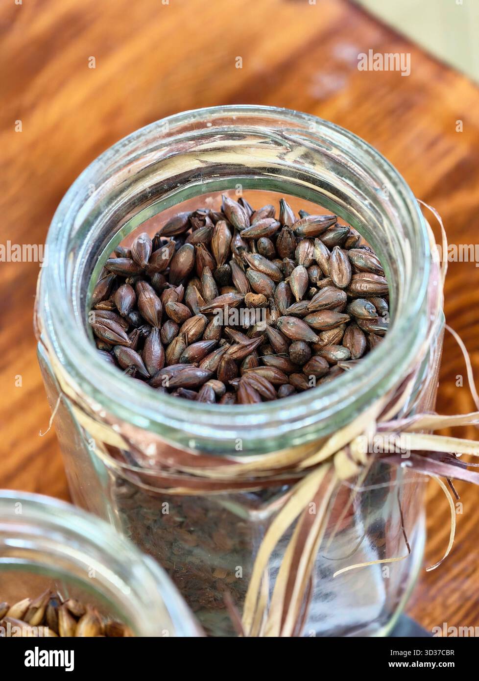 Various jars filled with malt grains showcasing their rich color and ...