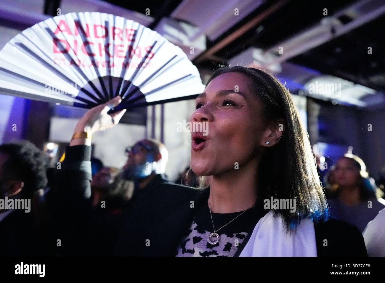 An attendee cheers as Atlanta Mayor Andre Dickens speaks during an ...