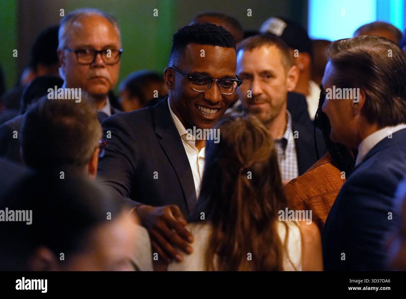 Democrat Christian Menefee meets with attendees during an election ...