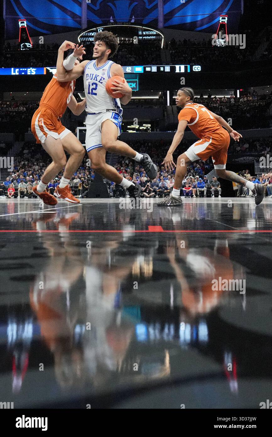 Duke forward Cameron Boozer drives to the basket between Texas forward ...