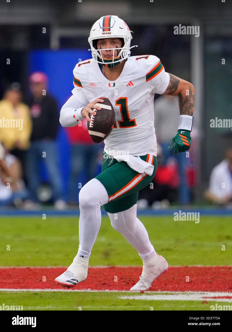 Miami quarterback Carson Beck scrambles during an NCAA college football ...