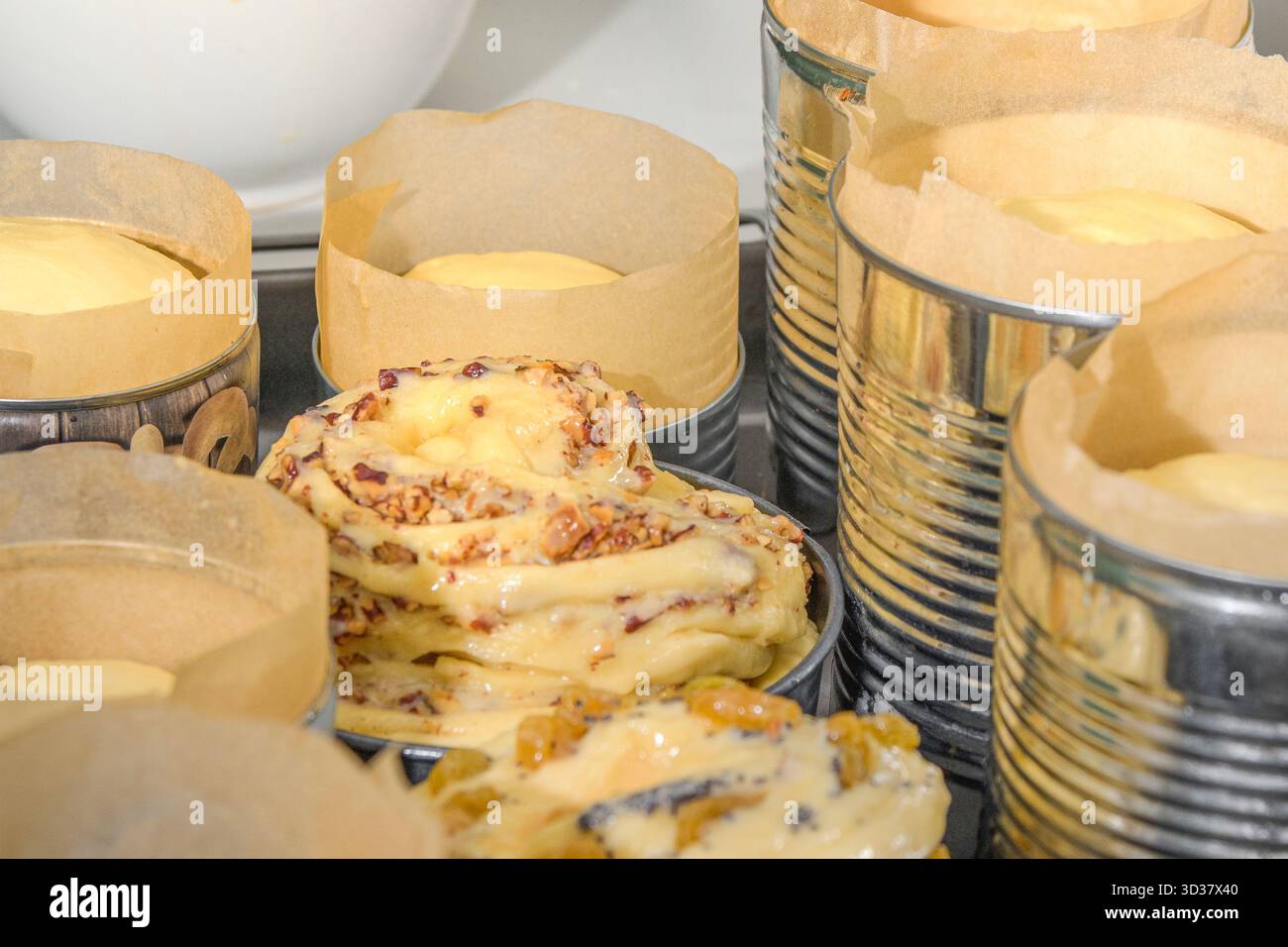 Cylindrical forms for home baking made from empty tin cans. Focus on ...