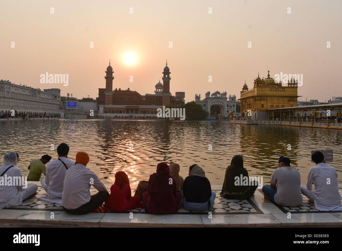 The sun rises as devotees pay obeisance at the Golden Temple to mark ...