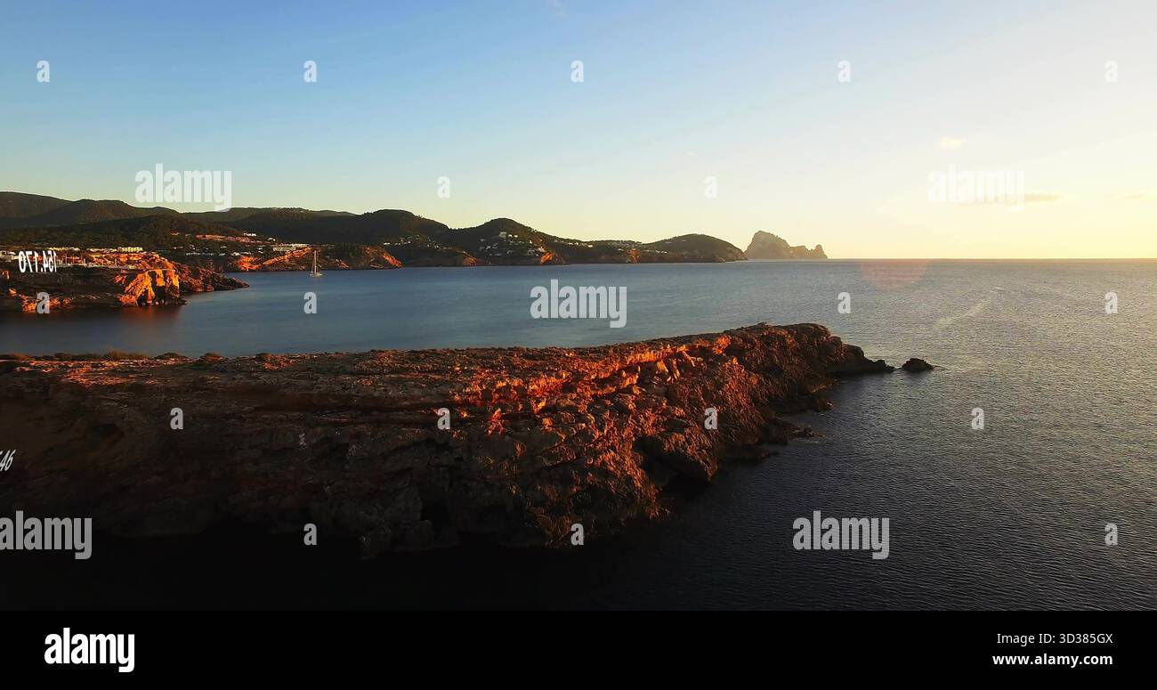 Basking rocky headland glowing at seaside, featuring hillside sign ...