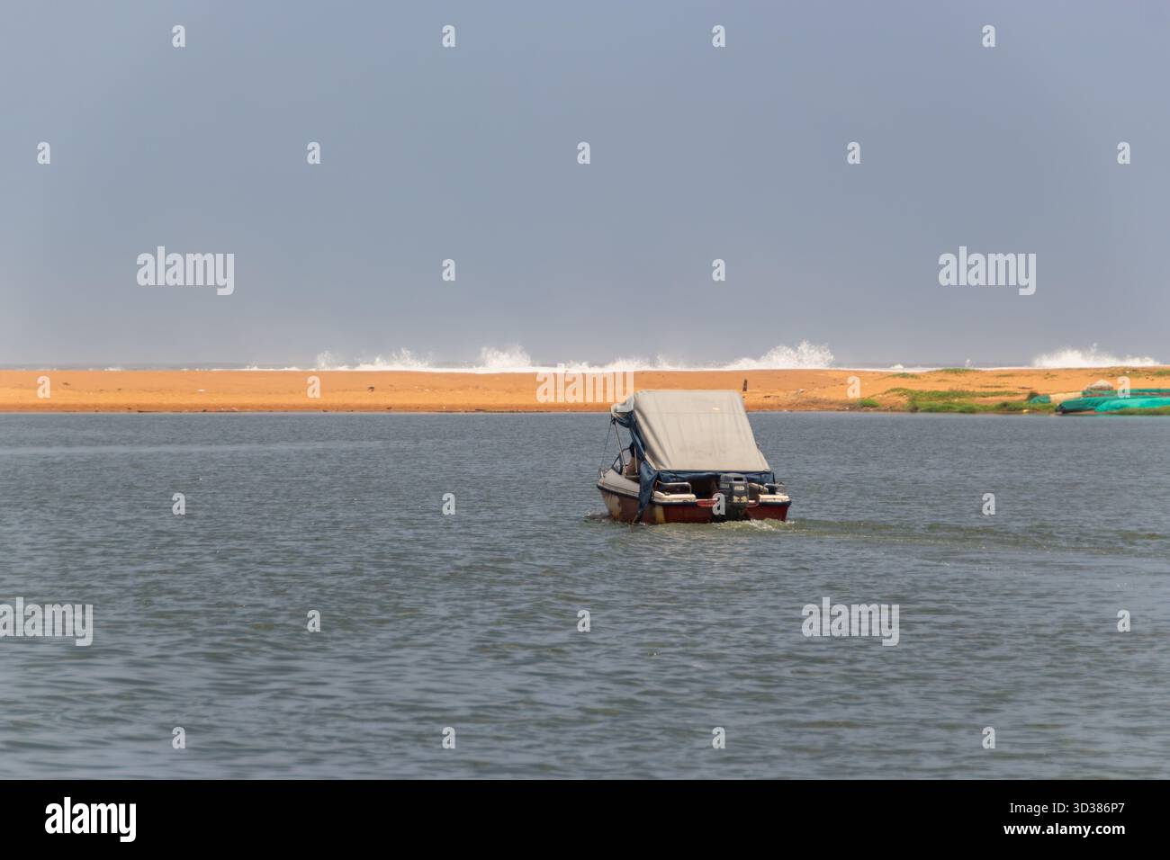 Small Motorboat Moving Across Inland Water with Distant View of Ocean ...