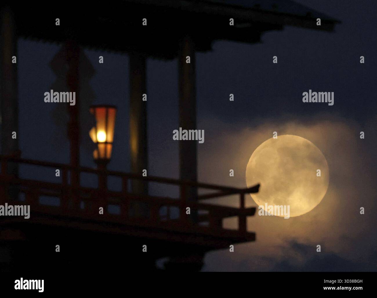 The photo shows the largest full moon of the year, a "supermoon," on ...