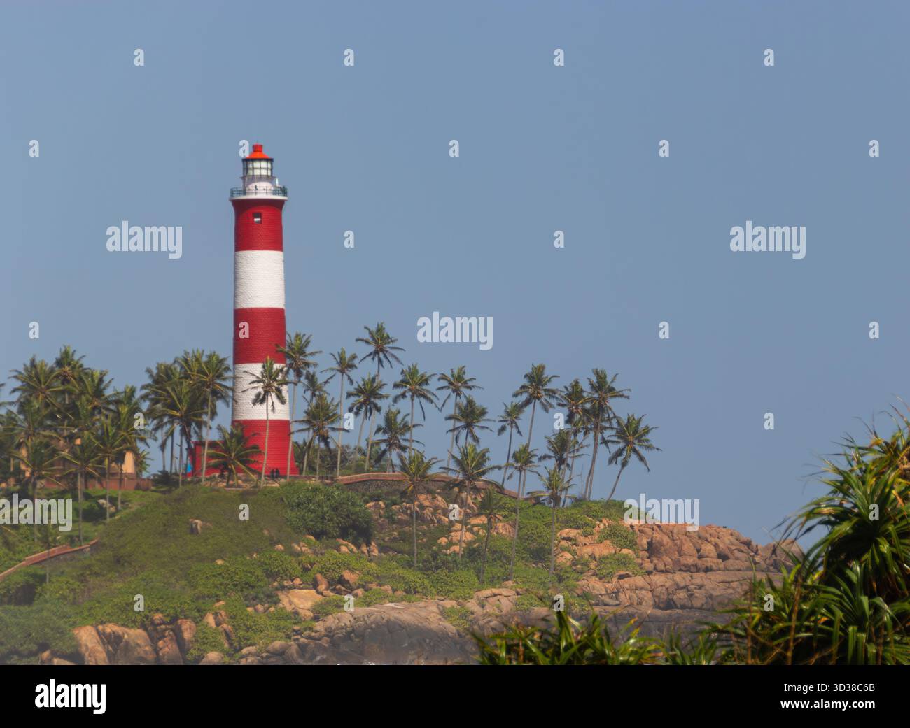 Red and White Striped Lighthouse Standing Tall on a Tropical Headland ...