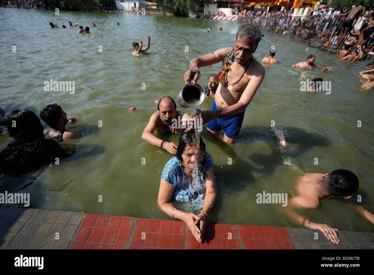 Devotees take a ritualistic bath during the annual Jhiri Fair at ...