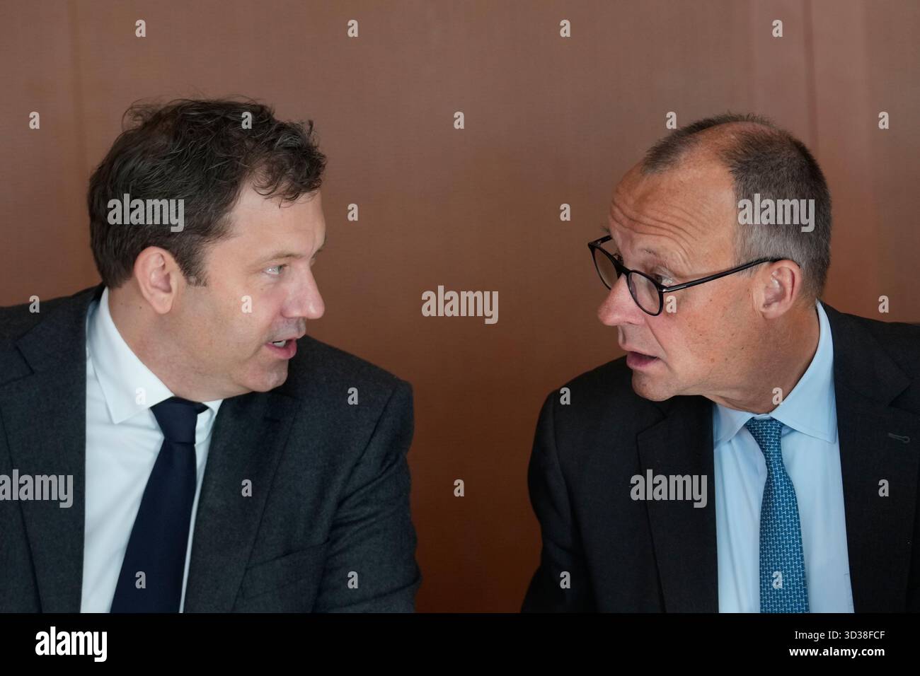 German Chancellor Friedrich Merz, right, talks to Vice Chancellor Lars ...