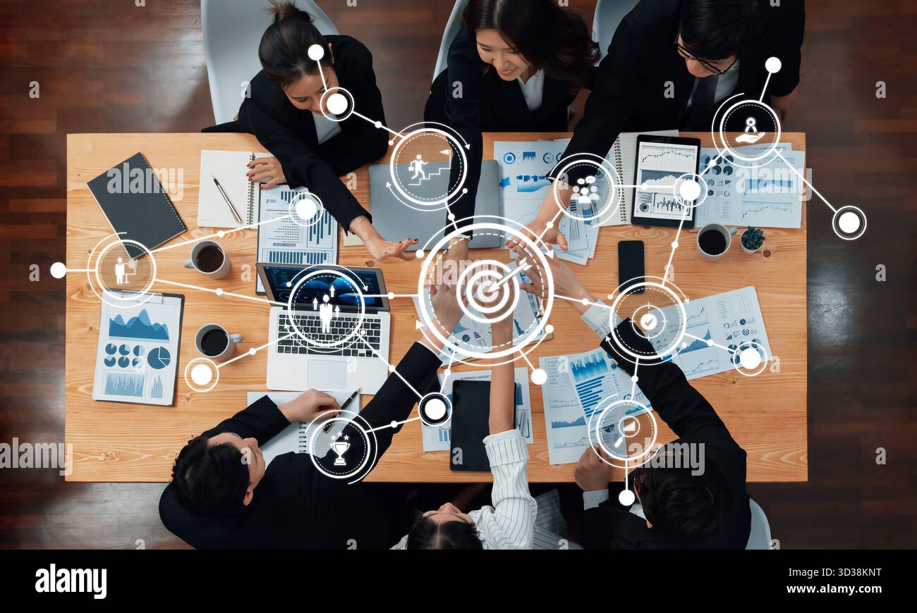 Collaborative Business Meeting Overhead View with Data Analytics Charts ...