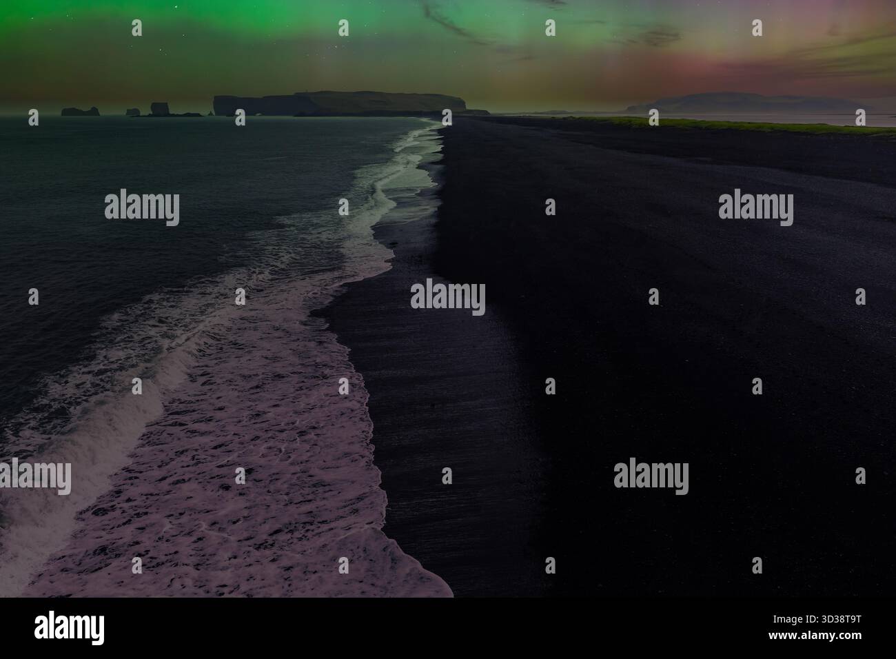 Aerial twilight of Reynisfjara and Dyrholaey with aurora over Vik Stock ...