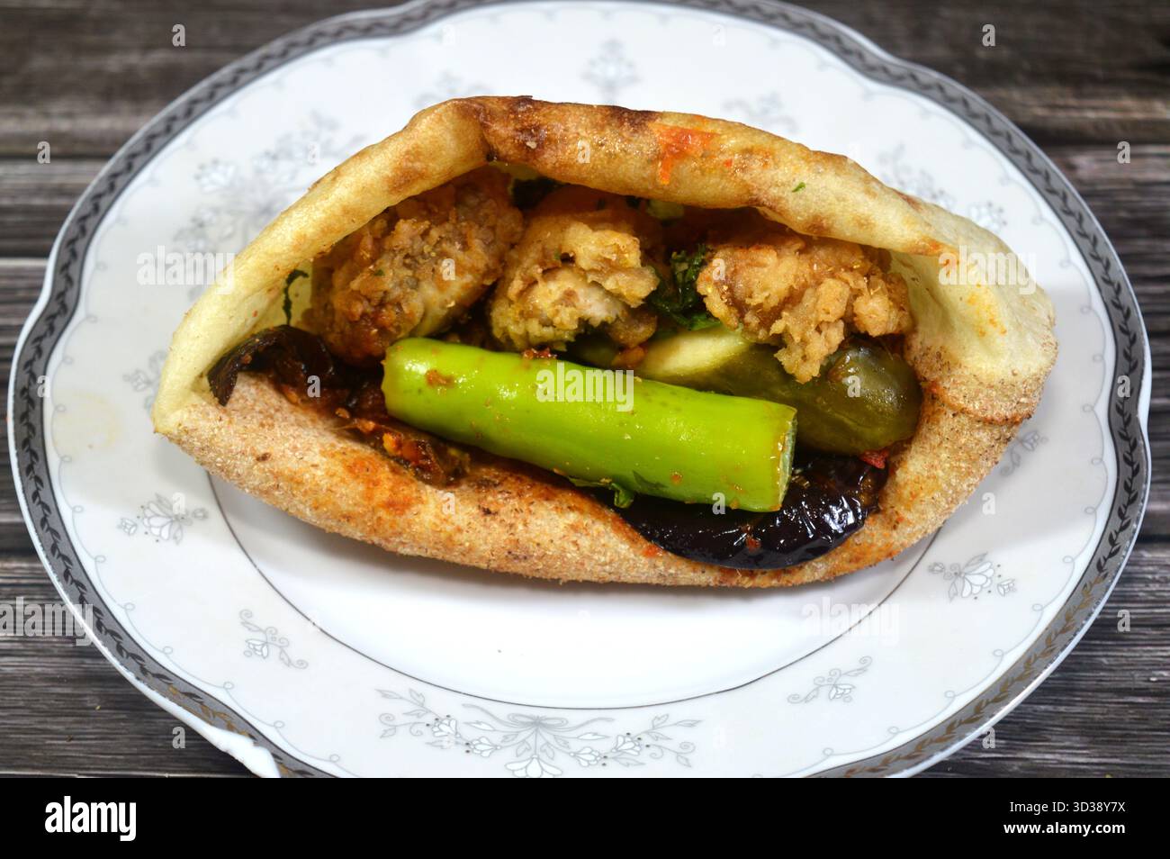 Cow beef brain covered with flour and fried in deep hot oil with green ...