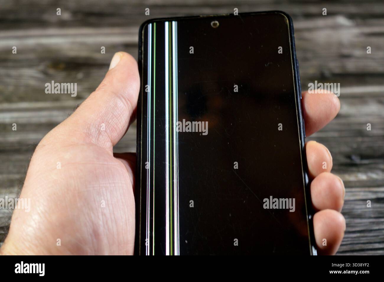 a smartphone with a damaged display, with a vertical lines on the ...
