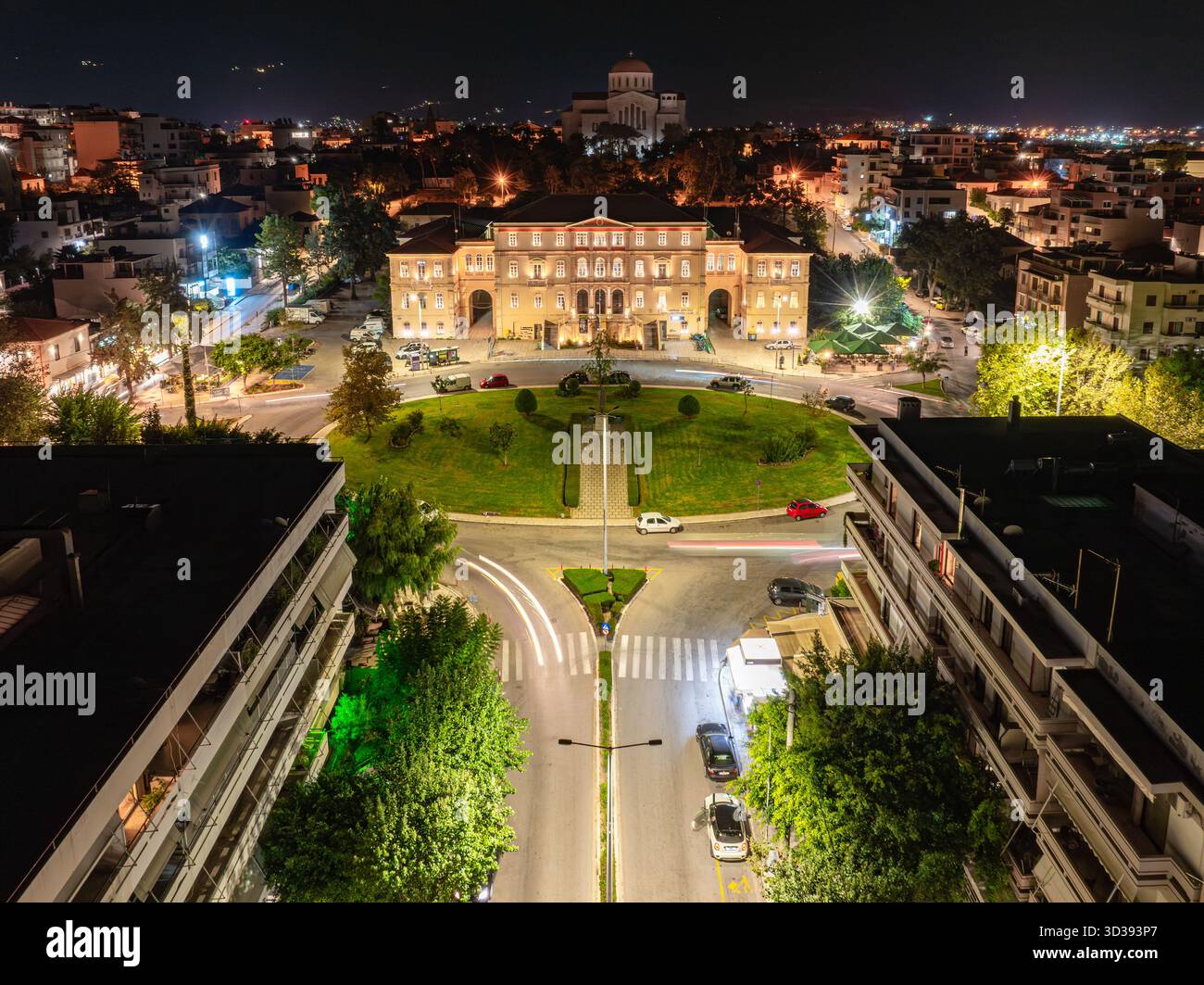 Aerial view of a roundabout with light streaks from passing cars ...