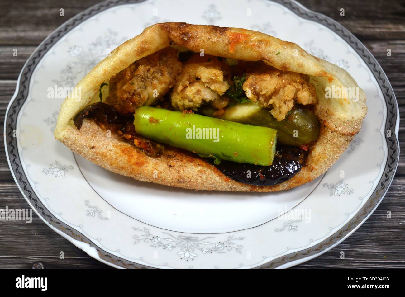 Cow beef brain covered with flour and fried in deep hot oil with green ...