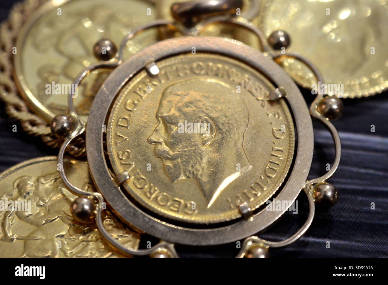 pile of King George V gold sovereign coins, features a left-facing ...