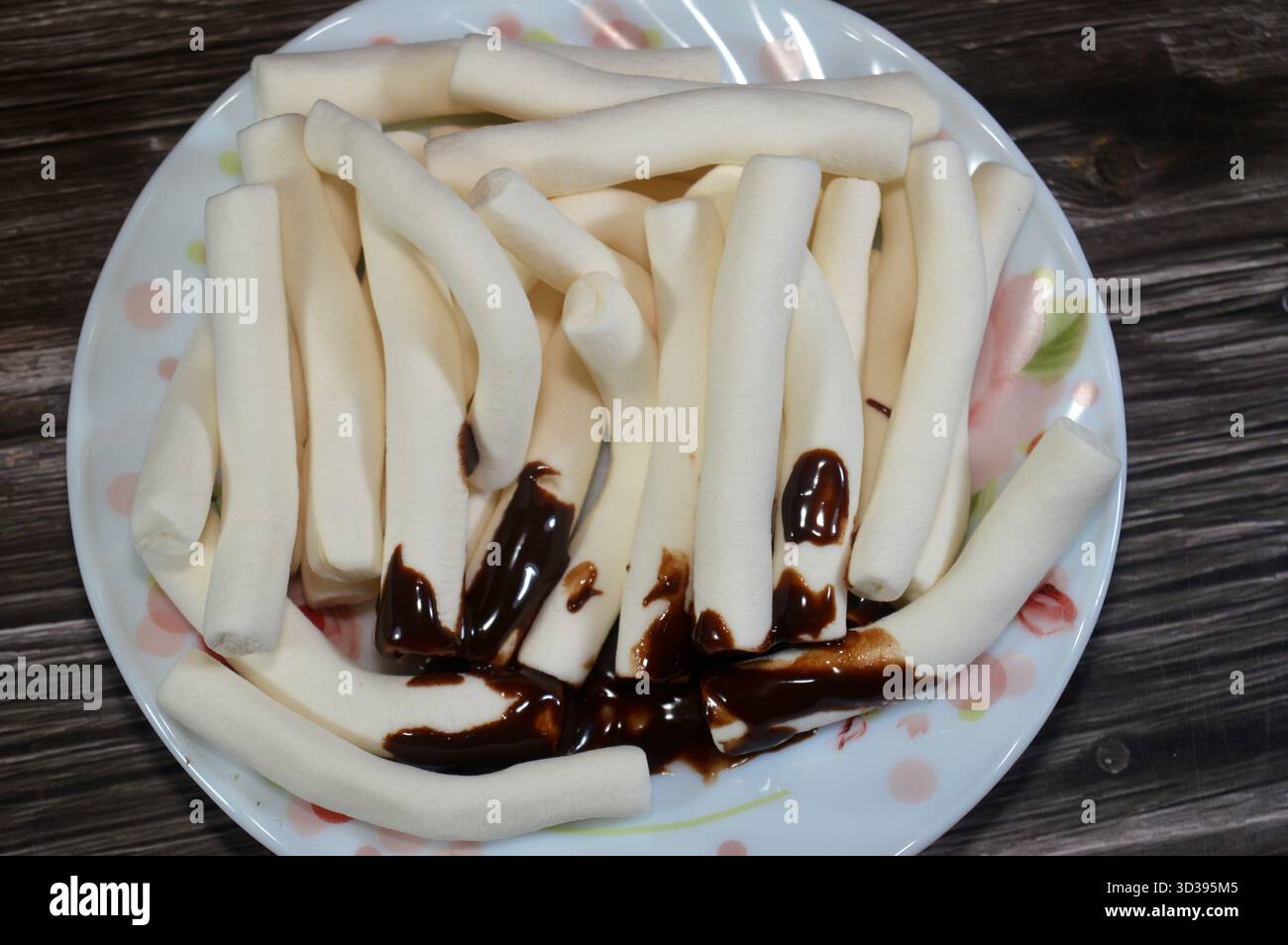 Chocolate sauce on Marshmallow sticks, a confectionery made from sugar ...