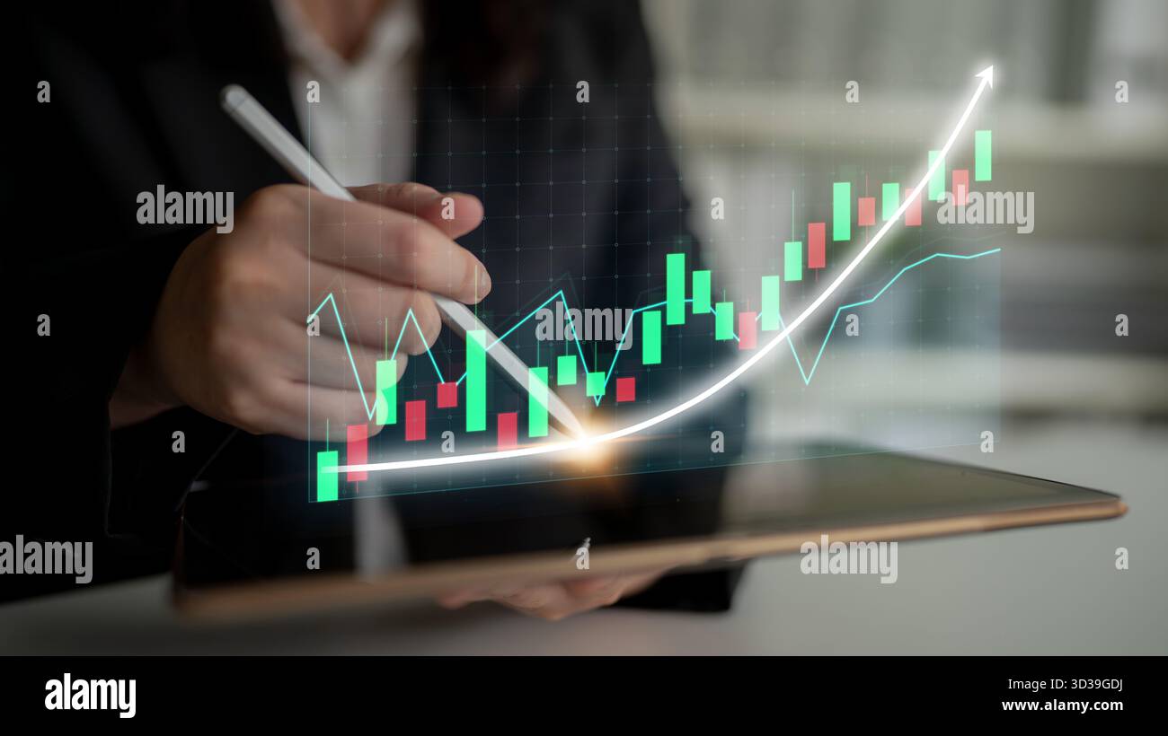 A professional individual analyzes a stock market graph on a digital ...