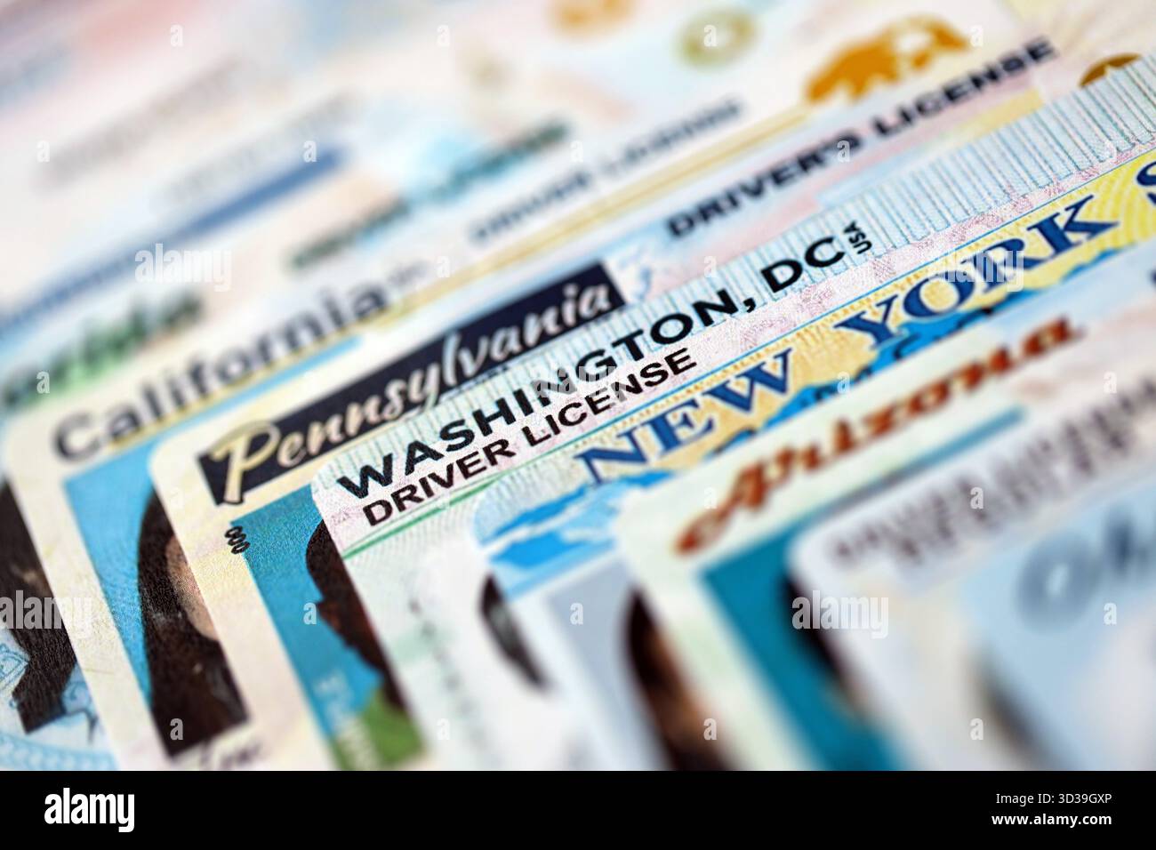 Big amount of driving licenses from different USA states. Stack of ...