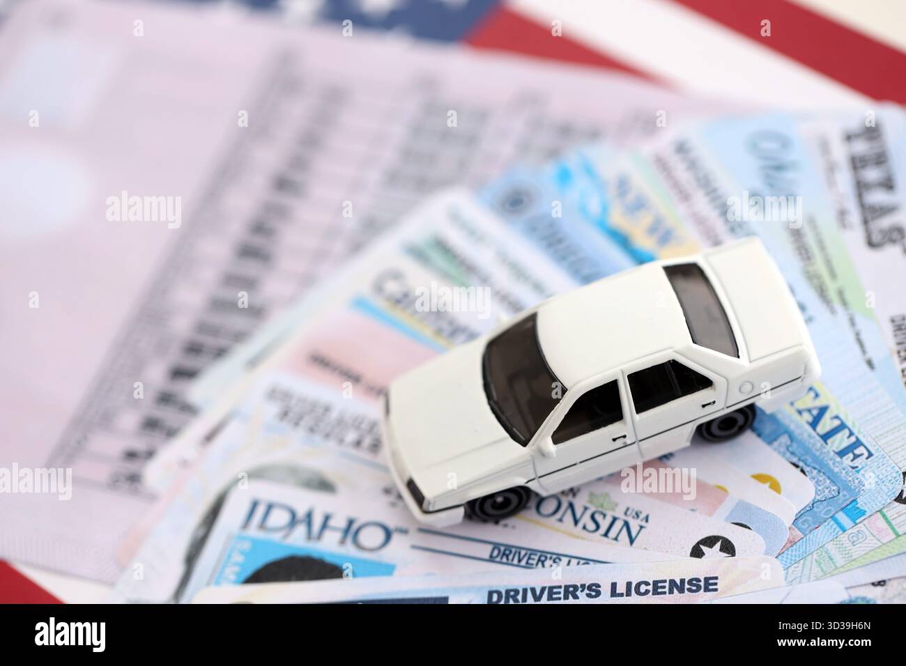 Toy car on big amount of driving licenses from different USA states on ...