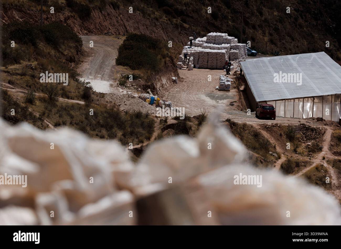 Bags of salt that have been weighed sit in a pile at Salineras de Maras ...
