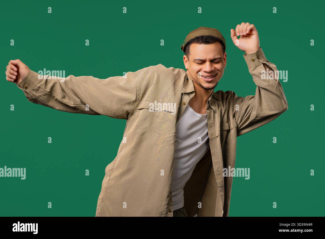 Active positive african man dancing on green background. Funny happy ...
