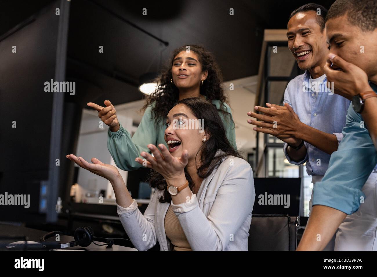 Diverse business team celebrating success together in modern office ...