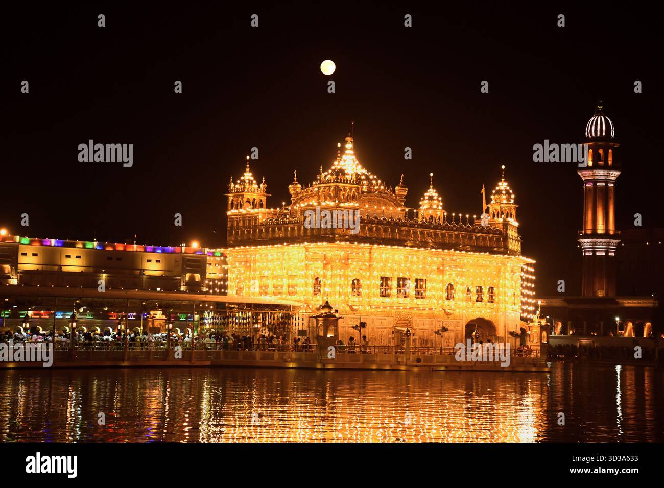 The supermoon rises behind the illuminated Golden Temple as Sikh ...