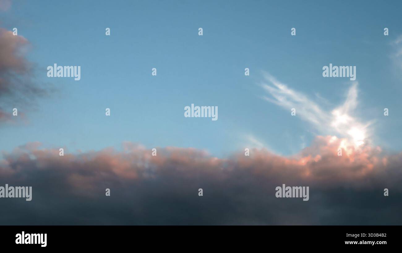 Blue, turquoise sky with a clear horizontal line of clouds that have a ...