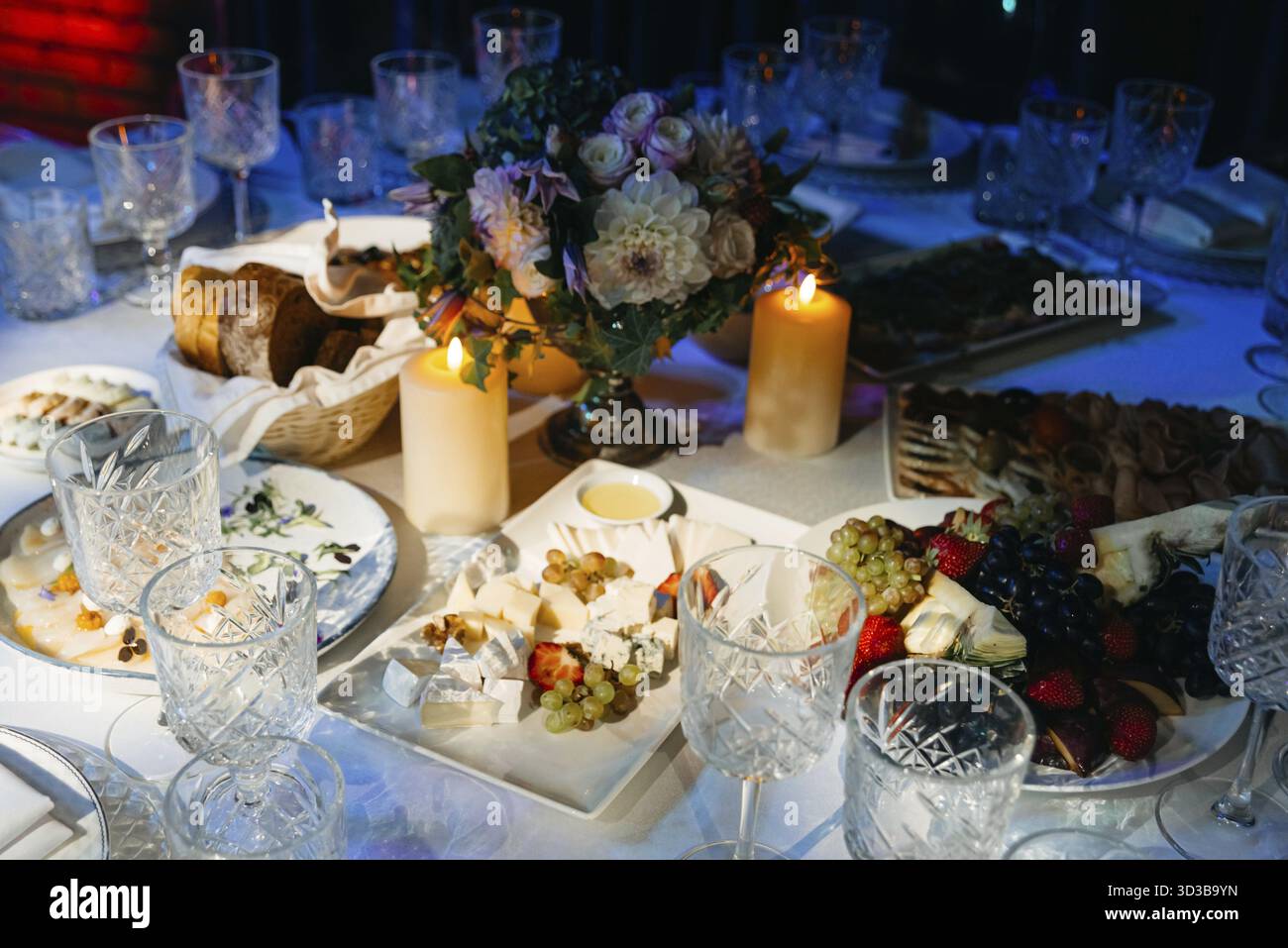 Food, Upscale dining setup with elegant glassware, floral centerpiece ...
