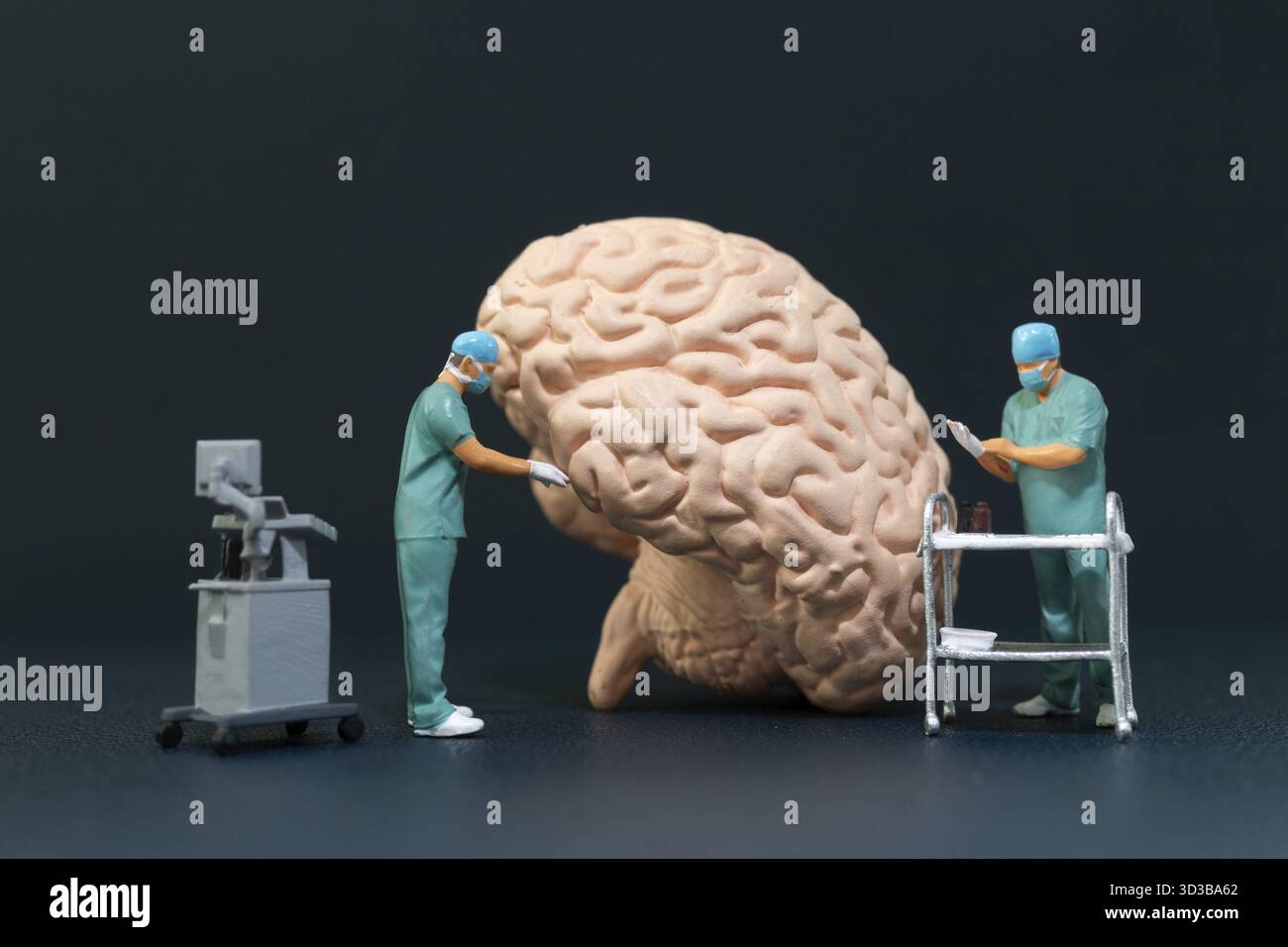 Miniature people of surgeons examining a large brain model. symbolizing ...