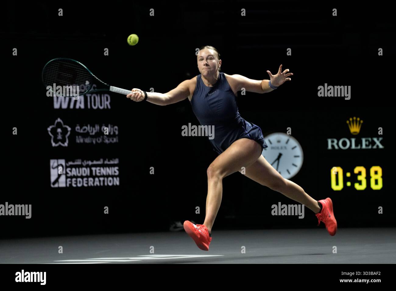 Amanda Anisimova of the United States lunges to return a ball to Iga ...