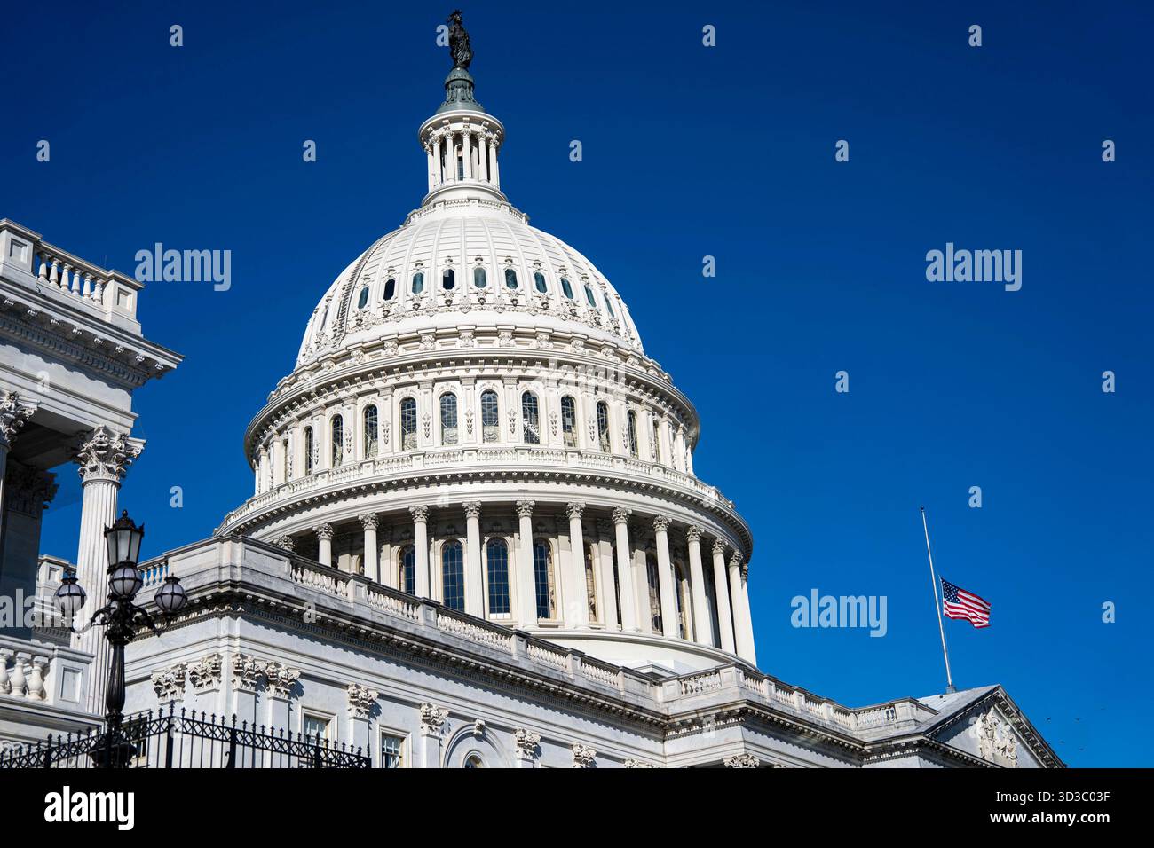 The American flag flies over the U.S. Capitol at half staff in honor of ...
