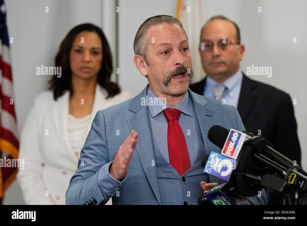 Attorney Mark P. Meuser, center, speaks to reporters during a press ...