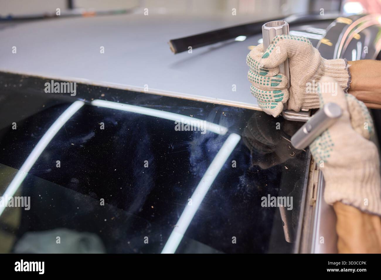 Installing windshield on a car with automotive design Stock Photo - Alamy