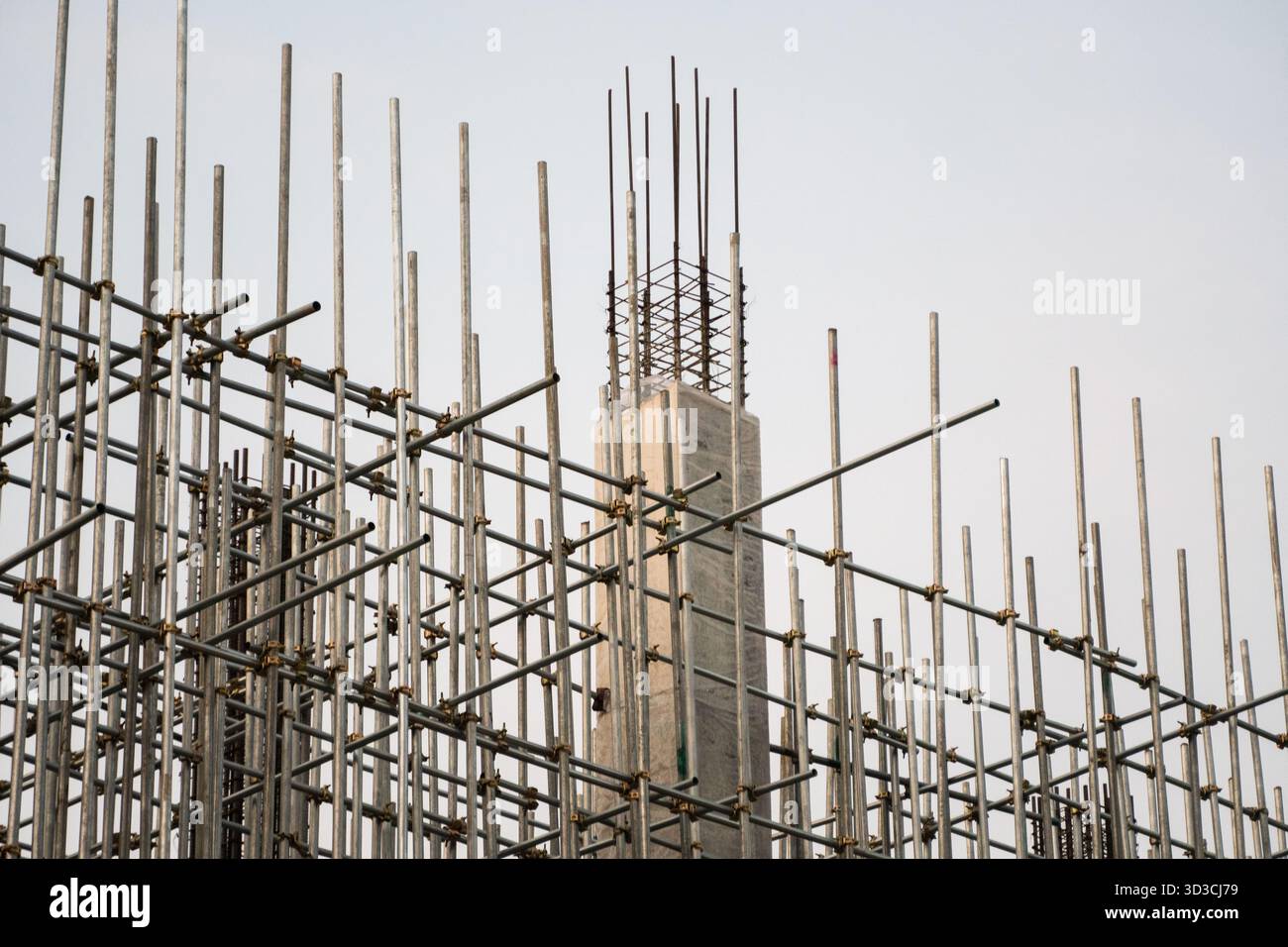 Concrete pillar with metal scaffolding structure on building site ...