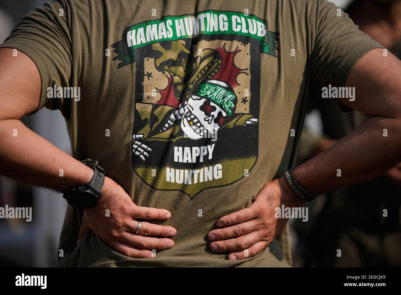 An Israeli soldier wears a T-shirt reading "Hamas Hunting Club, Happy ...
