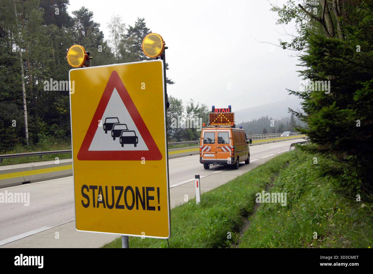 a traffic congestion warning road sign standing on the street traffic ...