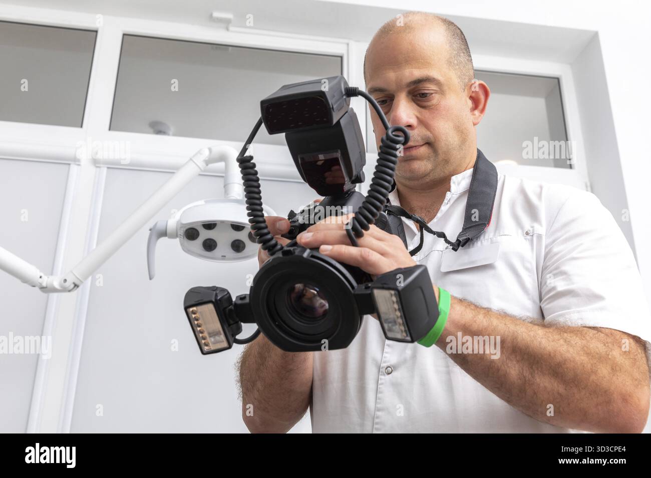 Dentist taking picture of mouth, his work on teeth of female patient ...