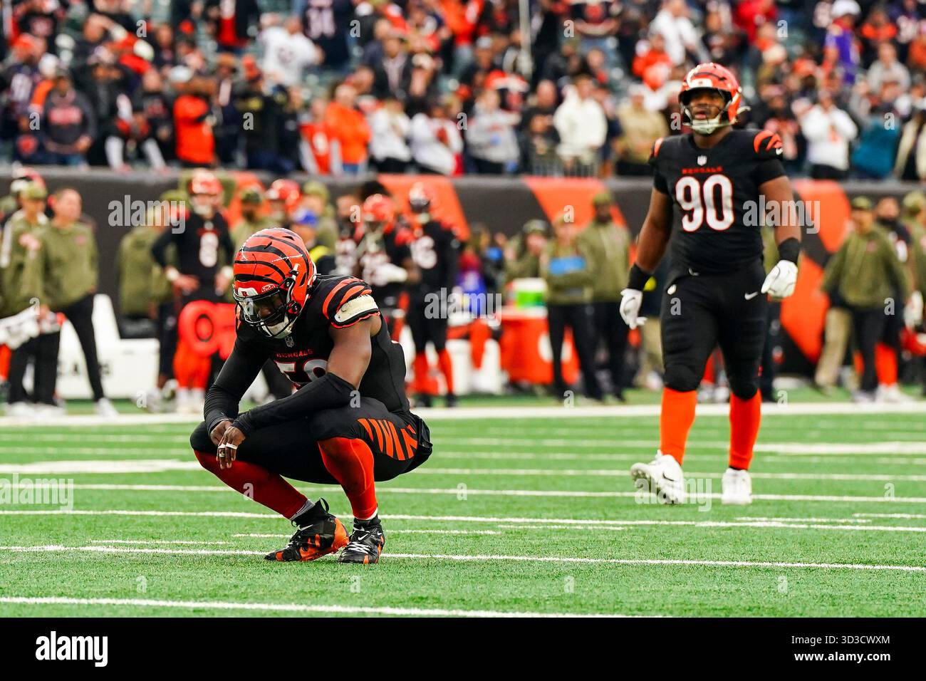 Cincinnati Bengals' Joseph Ossai (58) and Kris Jenkins (90) react to a ...