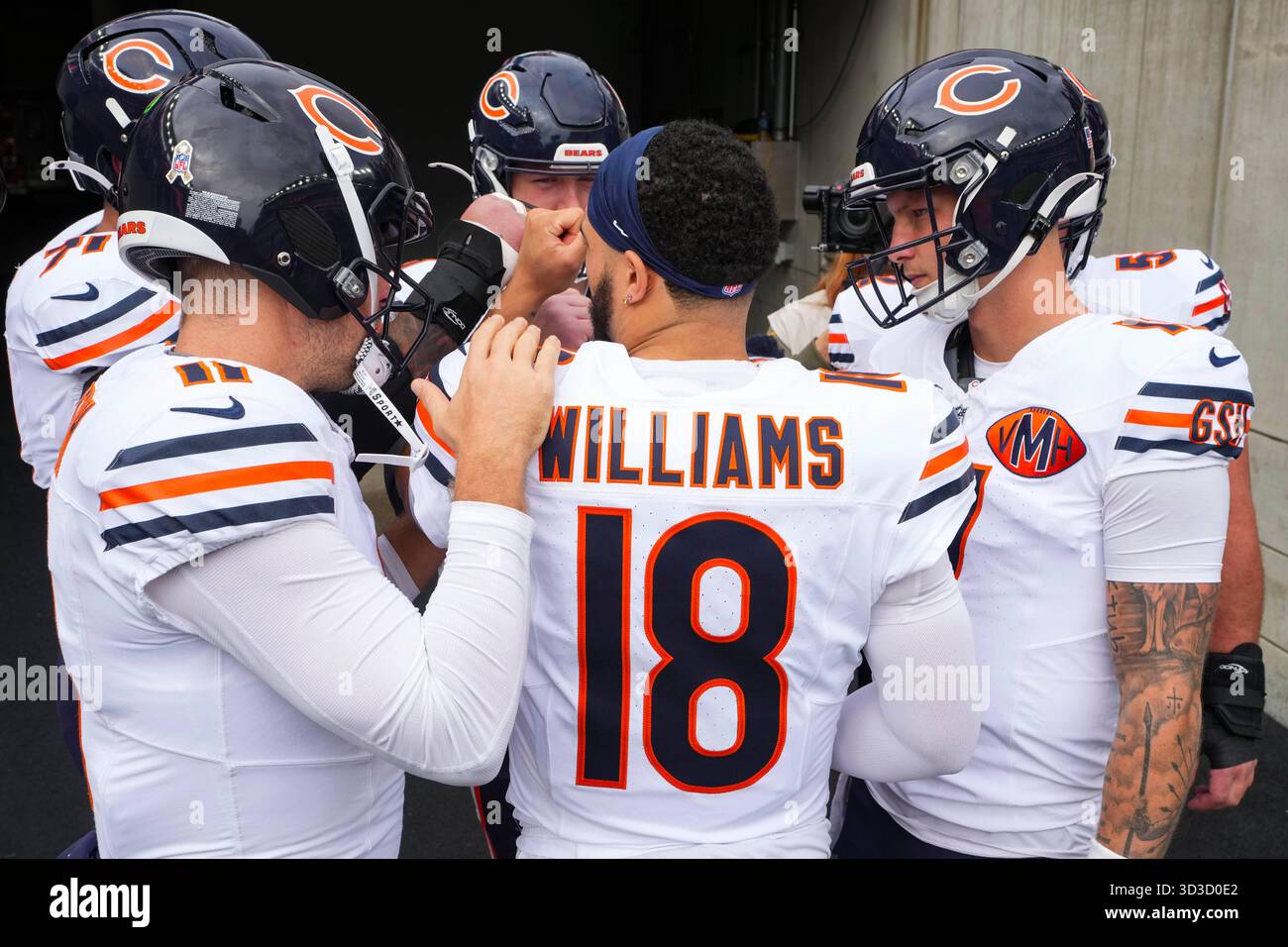 Chicago Bears quarterback Caleb Williams (18) huddles with teammates ...